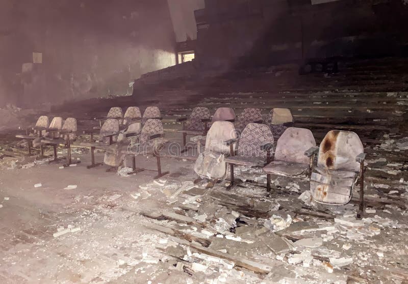 Empty, Burned Metal Chairs are Scattered Across a Dirt Room Stock Image ...