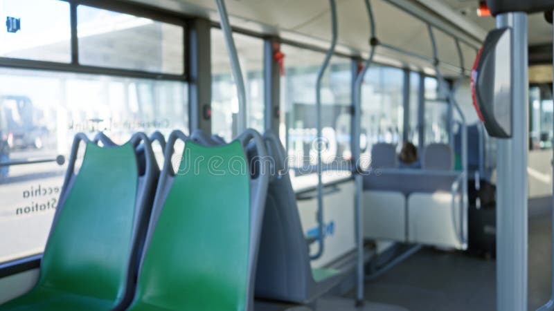 Empty Bus Interior Featuring Blurred Green Seats with a Defocused ...