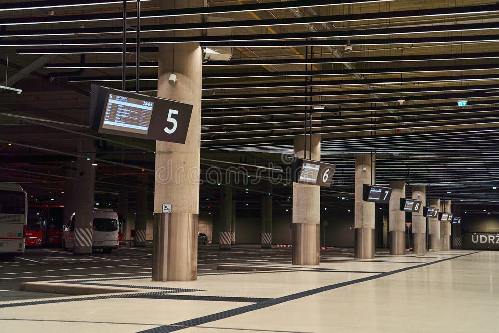 An Empty Bus Station Inside with Parked Buses and Large Columns ...