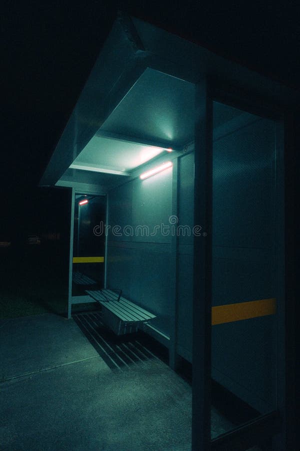An Empty Bus Stop at Night with the Lights on and Light on Stock Photo ...