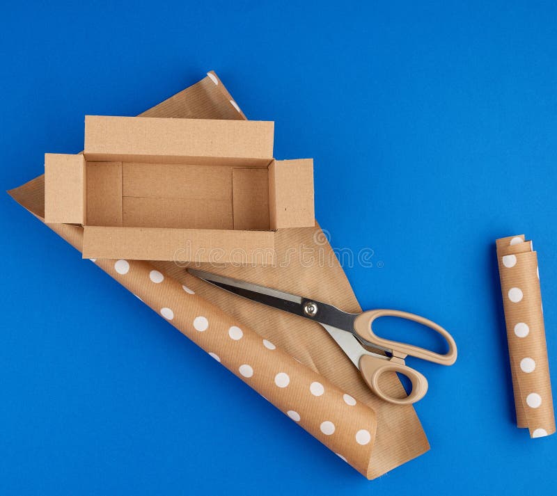 Empty Cardboard Brown Box, Roll of Wrapping Paper and Scissors Stock ...