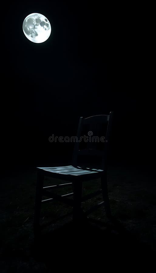 An Empty Chair Sits Alone Silhouetted Against the Night, Illuminated by ...