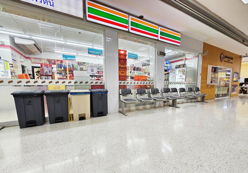Empty Chairs and Plastic Wheeled Trash Can in Front of a 7-Eleven ...