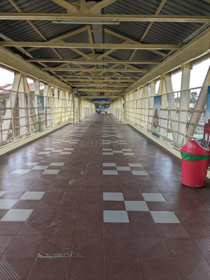 An Empty Checkered Walkway Leads To a Tunnel-like Structure in the ...