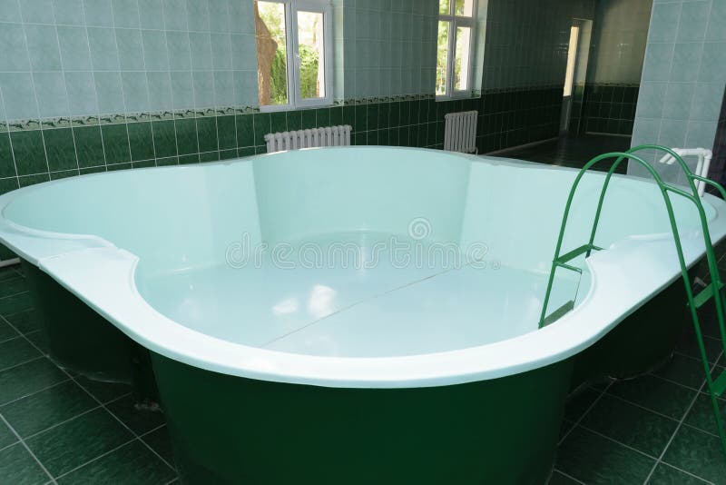 Empty Children`s Pool in the Bathroom with Windows Stock Photo - Image ...