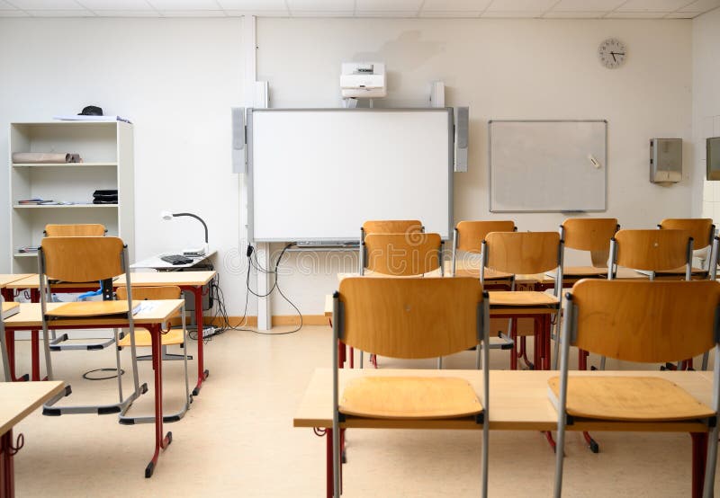 Empty Classroom with an Interactive Whiteboard, Desks and Chairs Stock ...