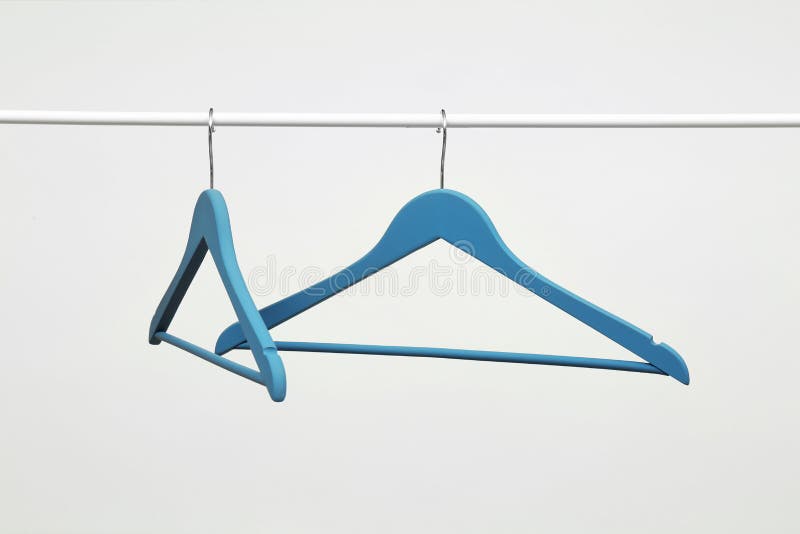 Empty Clothes Hangers on Metal Rail Against Light Backgrou Stock Photo ...