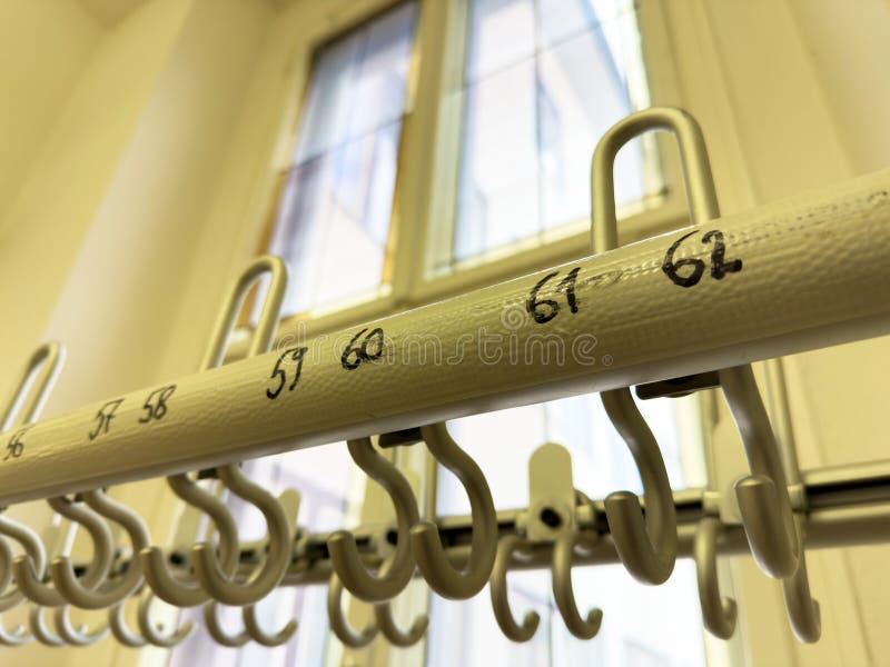 Empty Coat Rack Numbered Hooks in Bright Room with Large Window Stock ...
