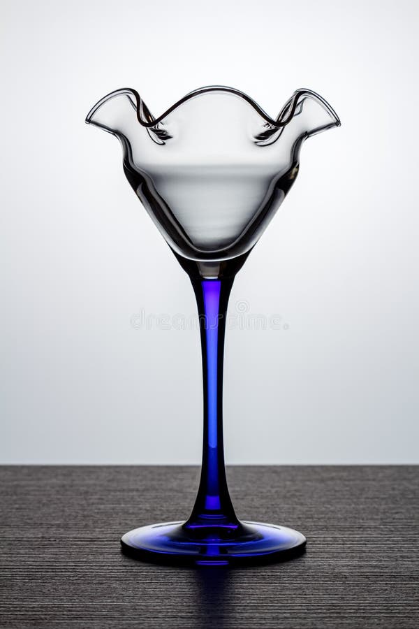 Empty Cocktail Glass with Blue Thin and High Leg on Dark Wooden Surface ...