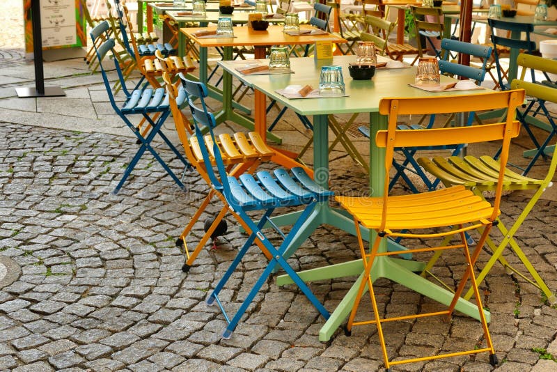 Empty Colorful Chais and Tables at an Outdoor Cafe on a Sidewalk Stock ...