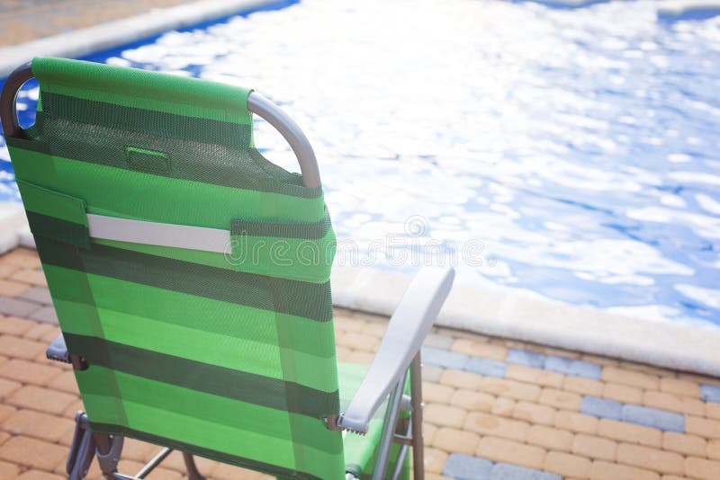 Empty Deck Chairs Under Straw Shade Umbrellas on Swimming Pool Side in ...