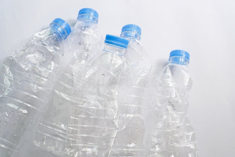 The Empty Deformed Clear Plastic Water Bottles with Blue Lid on White ...
