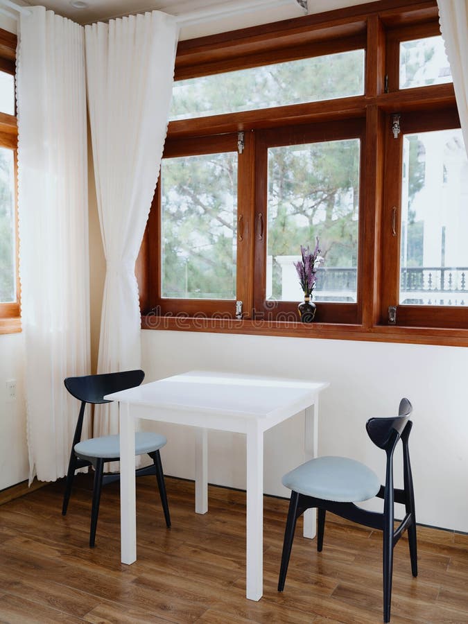 Empty Dining Table with Chairs in Light Interior by Window, Cozy Design ...