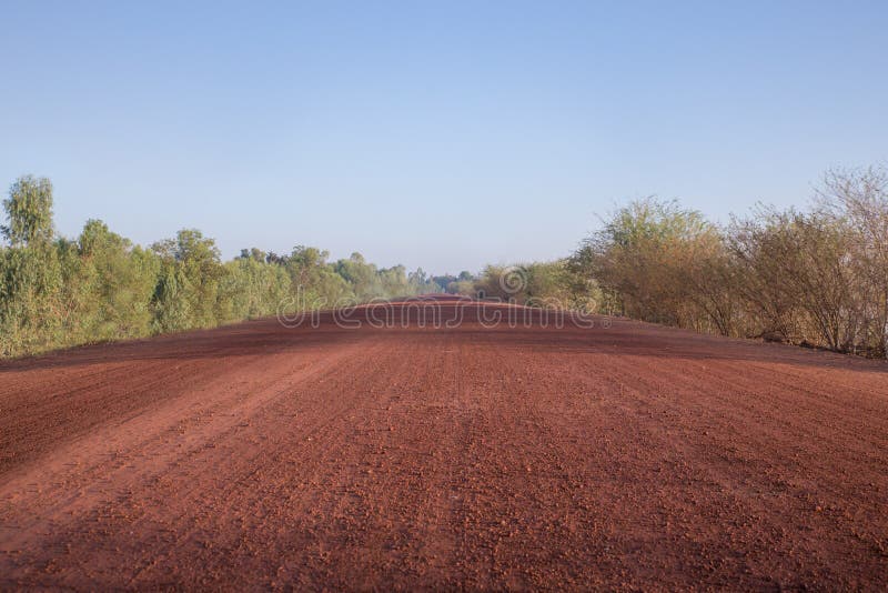An Empty Dirt Country Road To a Hill with Cottages Stock Image - Image ...