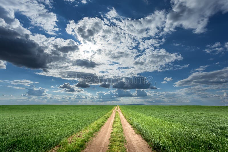 An Empty Dirt Country Road To a Hill with Cottages Stock Image - Image ...