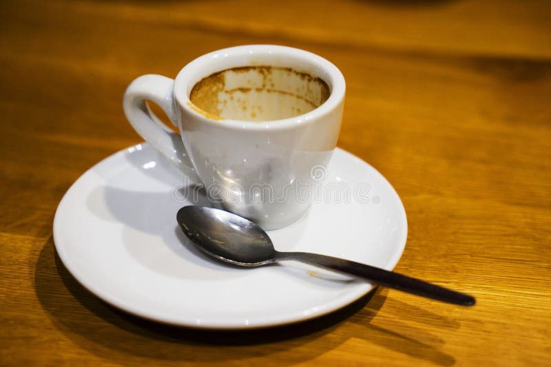 An Empty Dirty Cup with the Remains of Coffee on the Brown Table. Stock ...