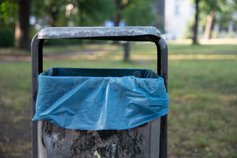 Empty, Dirty and Damaged Trash Bin in a Park Stock Photo - Image of ...