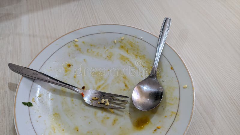 Empty and Dirty Plates on the Table. Fork and Spoon on a Dirty Empty ...