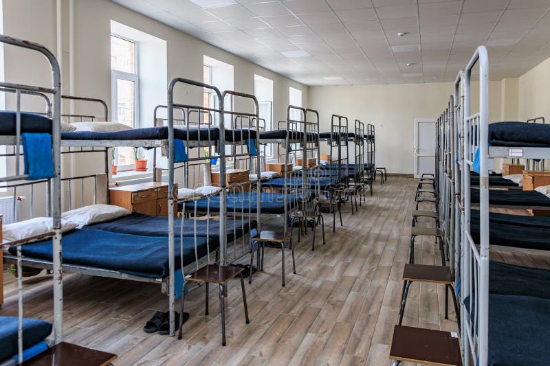 Empty Dormitory Room with Multiple Bunk Beds and Wooden Floor Stock ...
