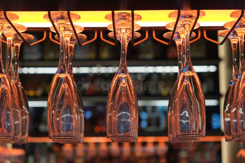 Empty Drinking Glasses Hanging in Bar Rack at Night Stock Image - Image ...