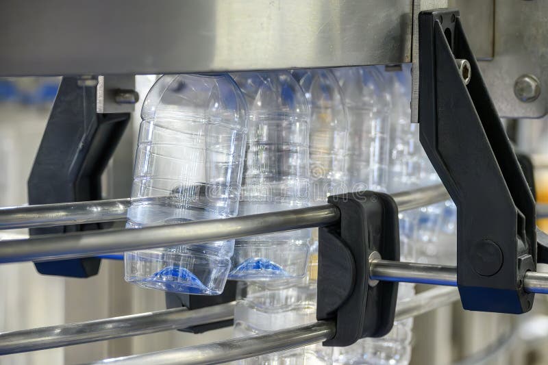 The Empty Drinking Water Bottles Hanging on the Conveyor Belt for ...
