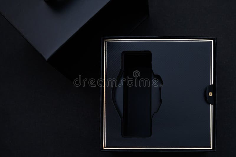 Empty Elegant Black Smartwatch Box with Gold Strip on Black Background ...
