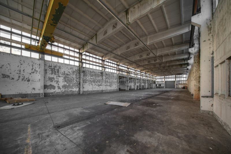 Empty Factory Hall with Peeling Walls, Exposed Beams, and Large Windows ...