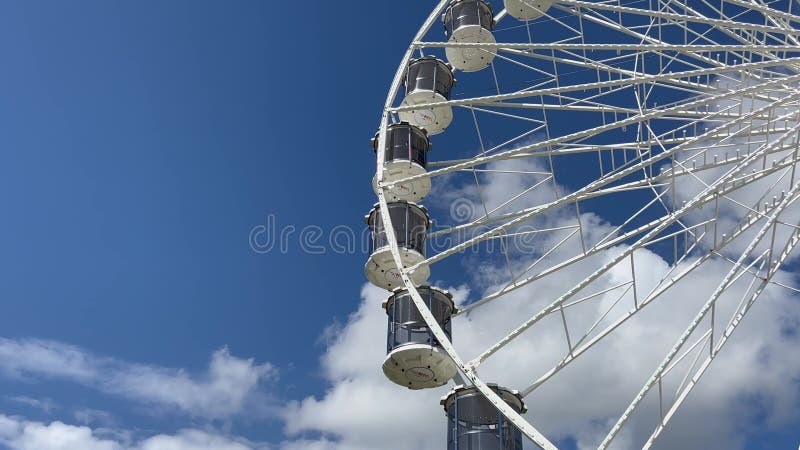 Empty Ferris Wheel Rotating Against Blue Sky with White Clouds Stock ...