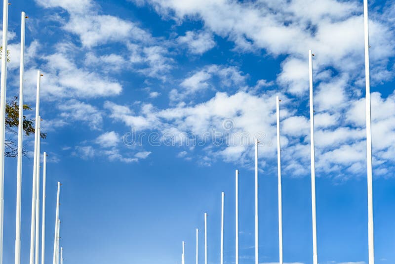 Empty Flag Poles Against BBlue Sky with Clouds Stock Photo - Image of ...