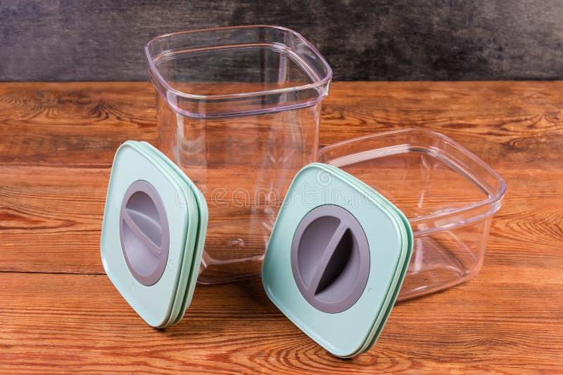 Empty Food Storage Containers with Open Lids on Rustic Table Stock ...