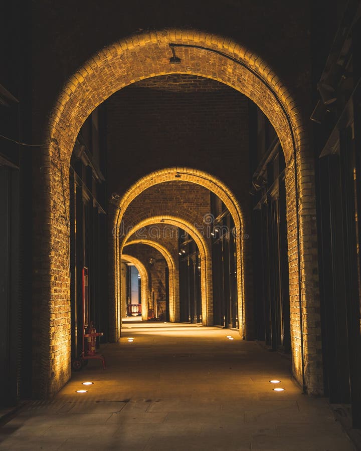 Empty Footpath Passing through an Archway Illuminated at Night Stock ...