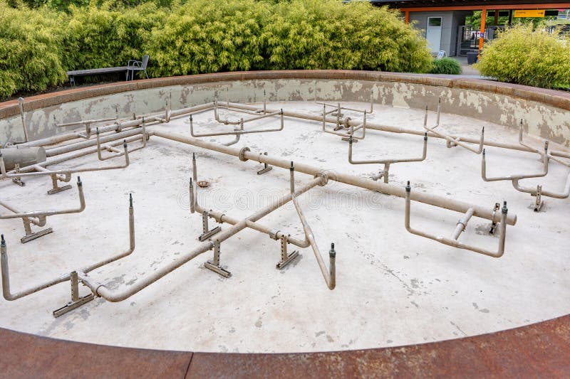 An Empty Fountain with a Complex Pipe System Can Be Seen in the Center ...