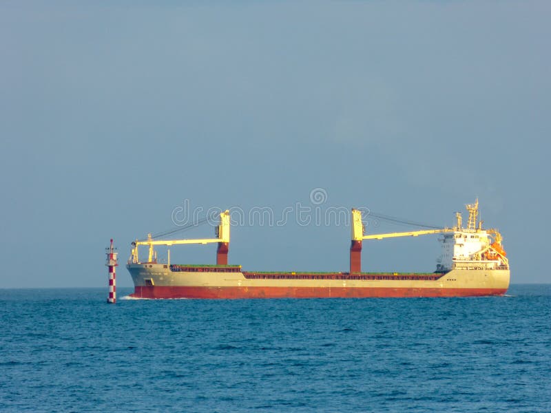 Empty Freight Ship on the High Seas Near Lighthouse Stock Image - Image ...