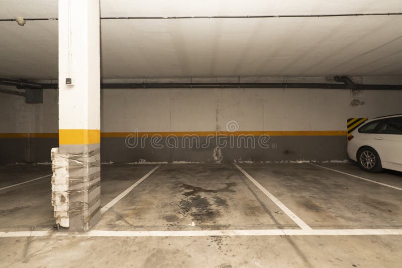 An Empty Garage Space with the Edges Painted White Stock Image - Image ...