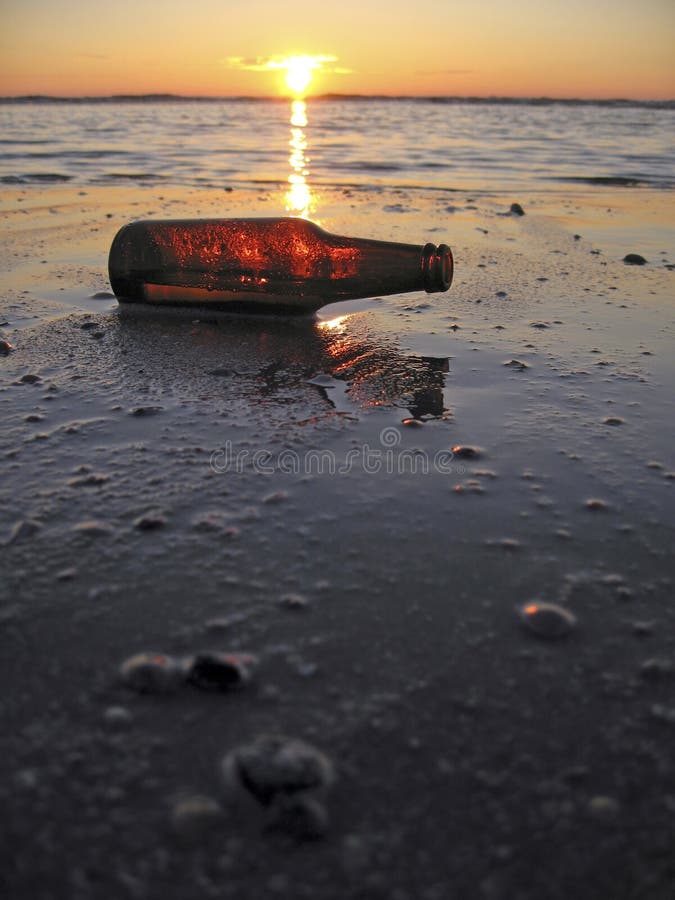 Empty Glass Bottle Lying in the Sea at the Beach at Sundown Stock Image ...