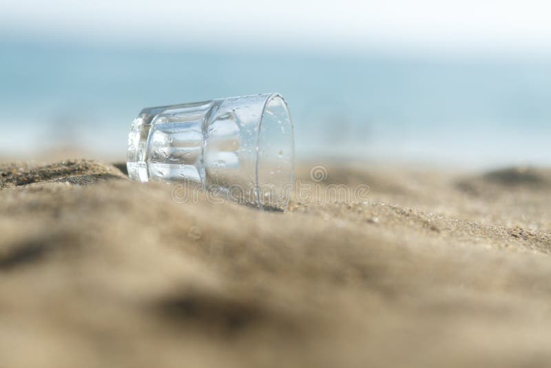 Empty glass Cup on sand stock photo. Image of brown - 159381282