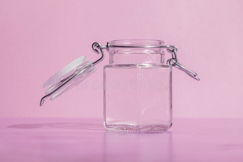 Empty Glass Jar with Open Lid and Metal Clasp on a Pink Background ...