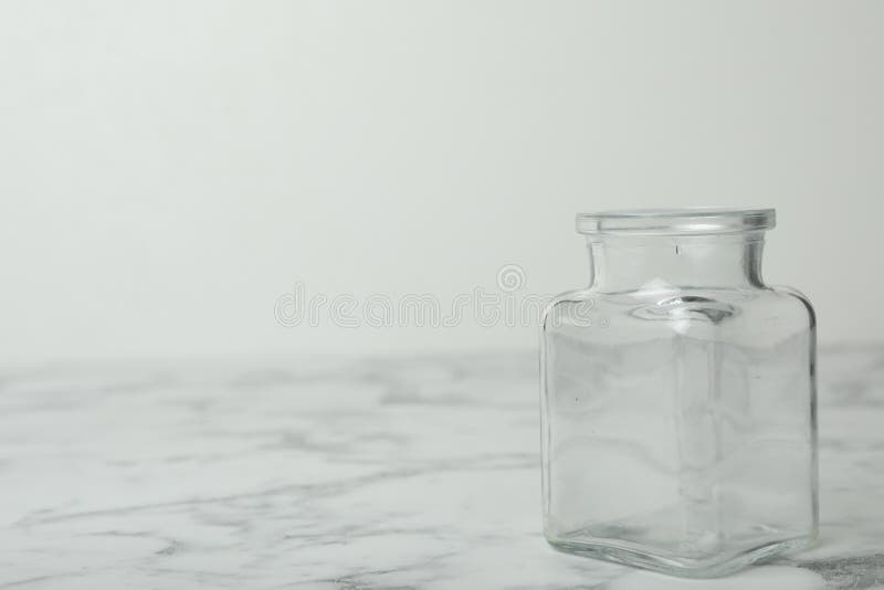 Empty Glass Jar on White Marble Table, Space for Text Stock Photo ...
