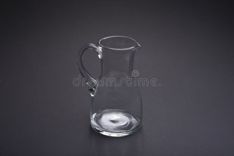 Empty Glass Pitcher on a Black Background Stock Image - Image of ...