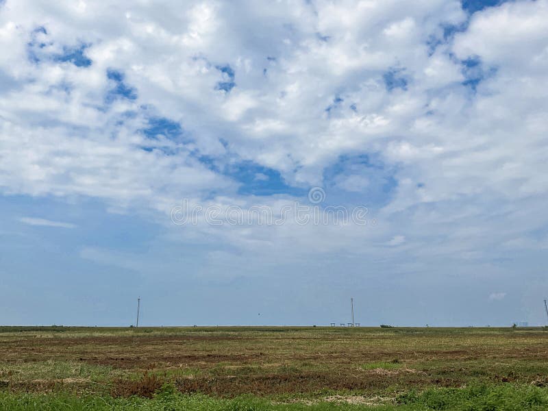Empty Grass Field and the Cloudy Blue Sky for Background Stock Photo ...