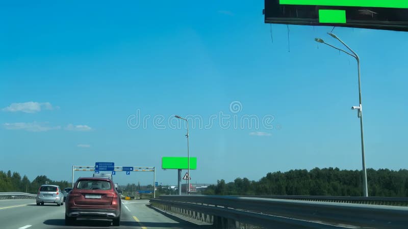 A Scenic Highway View Featuring Multiple Billboards with Green Screens ...