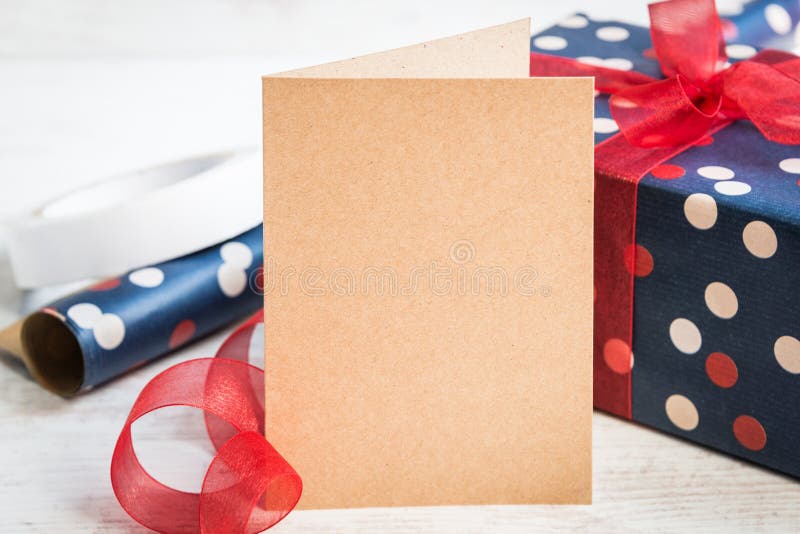 Empty Greeting Kraft Card. Wrapped Gift and Wrapping Materials Over a ...