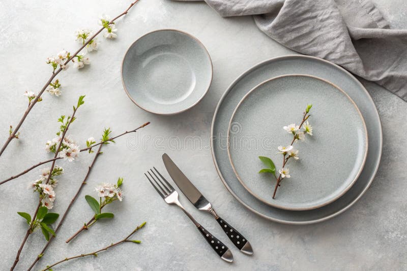 Empty Grey Plates on a Table with Fork and Knife. Spring Menu Concept ...