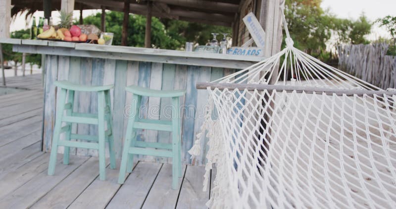 Empty Hammock Swinging and Stools by the Counter at Beach Bar, in Slow ...