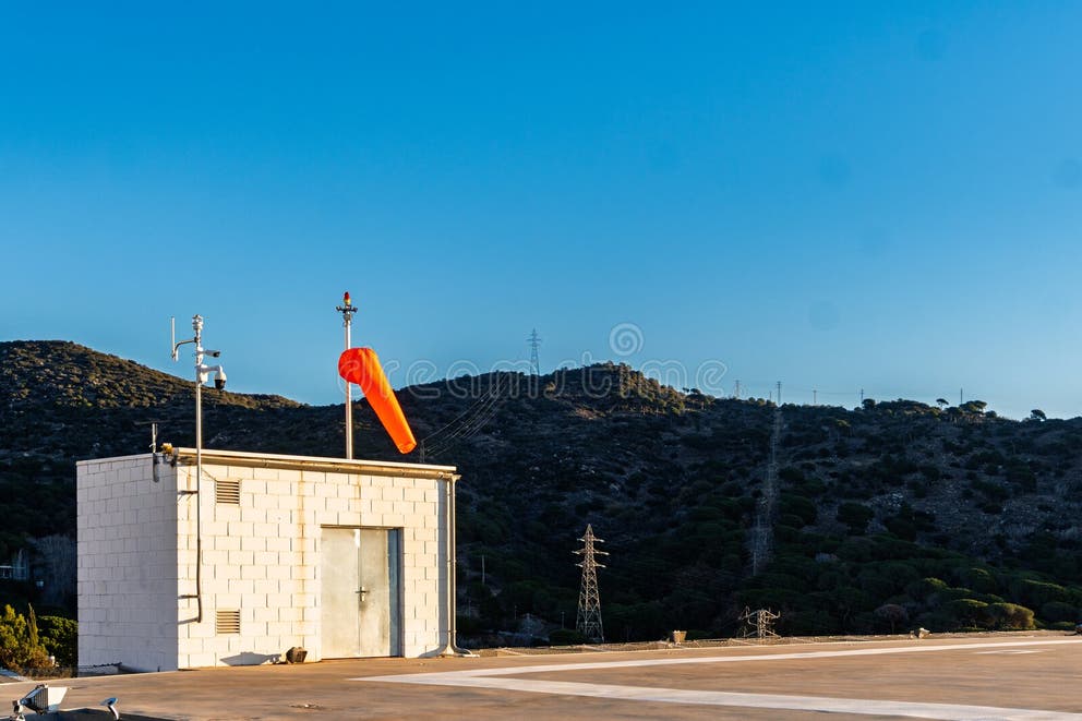 Empty Helipad on Building Roof with Windsock Indicating Wind Direction ...