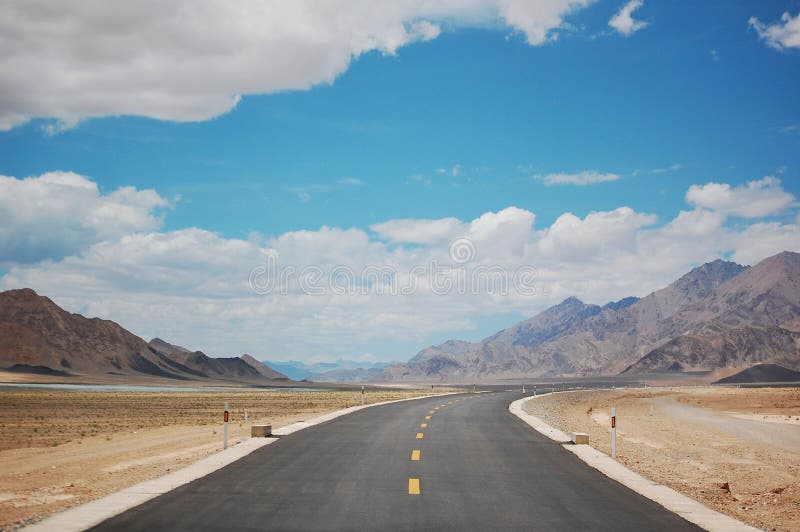 Empty Highway Alongside the Wide Field with Big Mountains in the ...