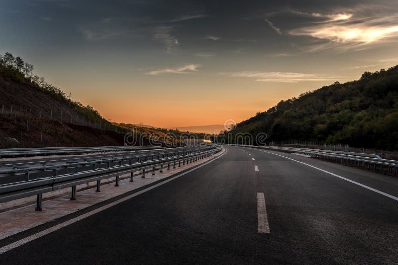 Empty highway at sunset stock image. Image of nature - 105300665