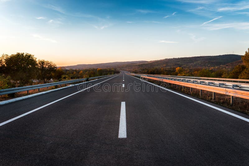 Empty highway at sunset stock image. Image of nature - 105300665
