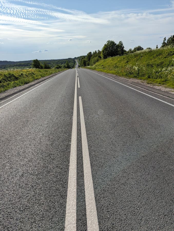An Empty Highway Under the Sky, Lined with White Parallel Stripes Stock ...