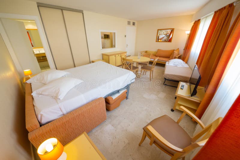 Empty Hotel Light Room with White Double Bed, Sofa Stock Image - Image ...